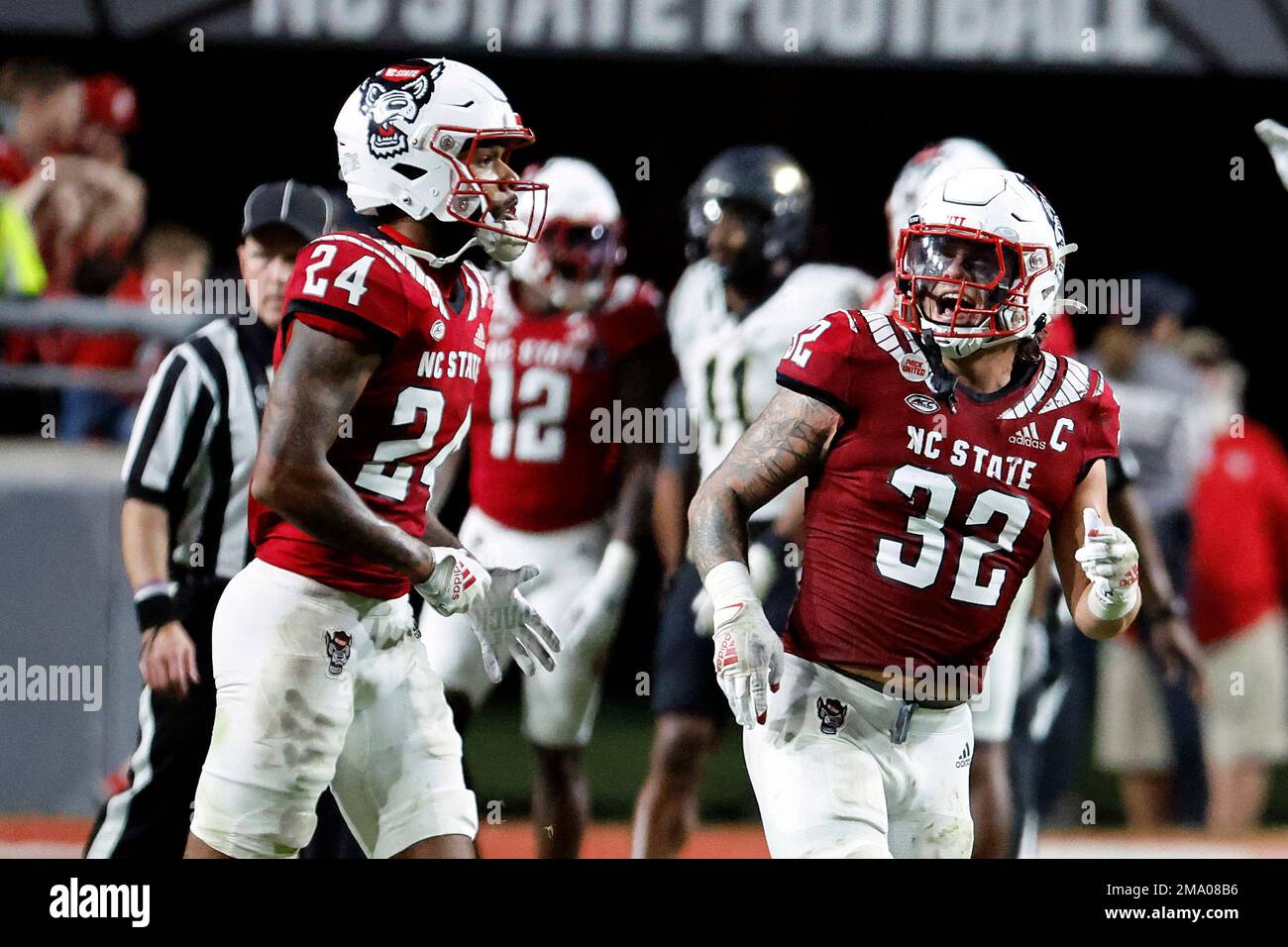 North Carolina State's Drake Thomas (32) congratulates teammate Derrek ...