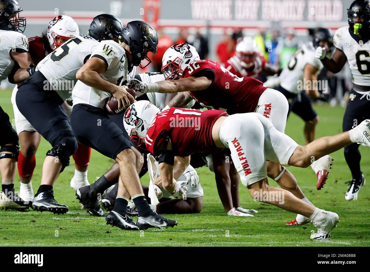 North Carolina State's Drake Thomas (32) and Payton Wilson (11) rush in ...