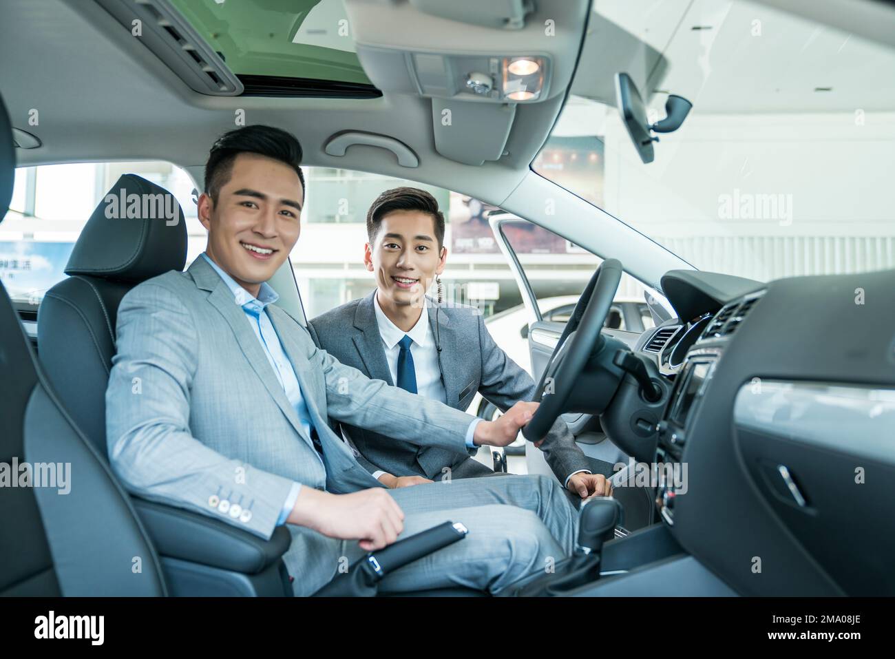 Young people in the car 4 s shop Stock Photo - Alamy