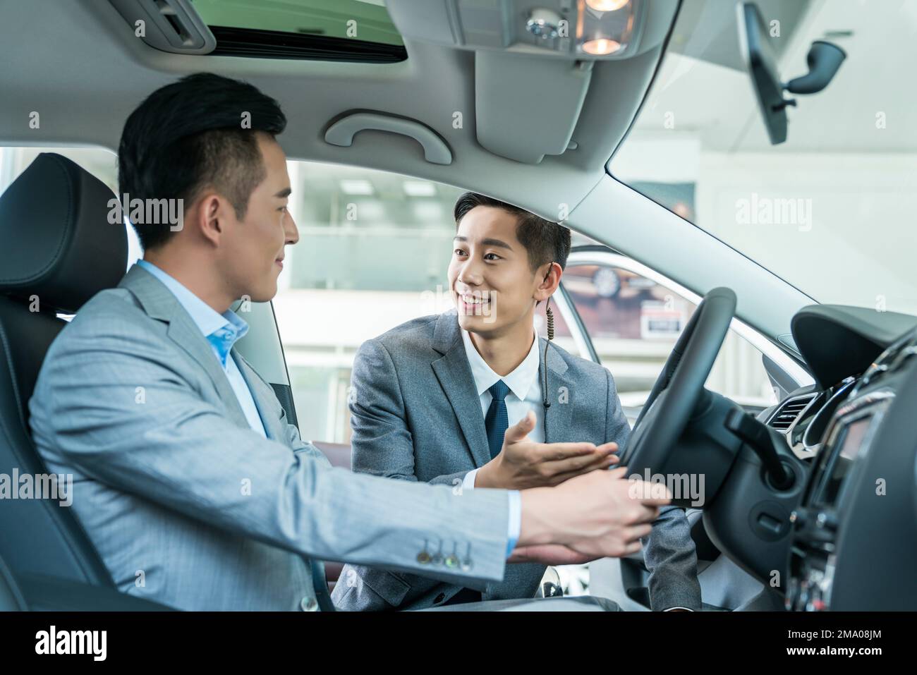 Young people in the car 4 s shop Stock Photo - Alamy