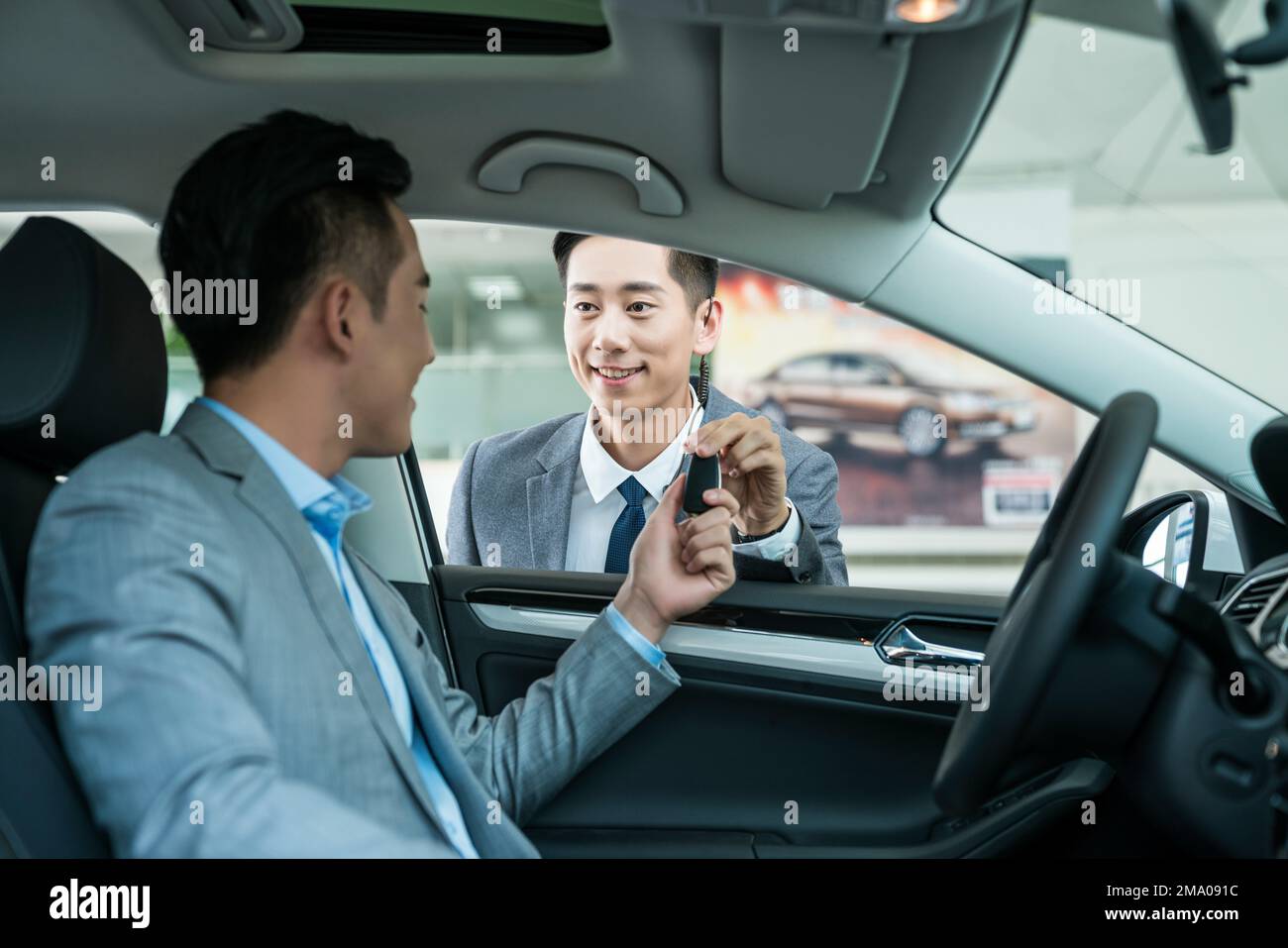 Young people in the car 4 s shop Stock Photo - Alamy