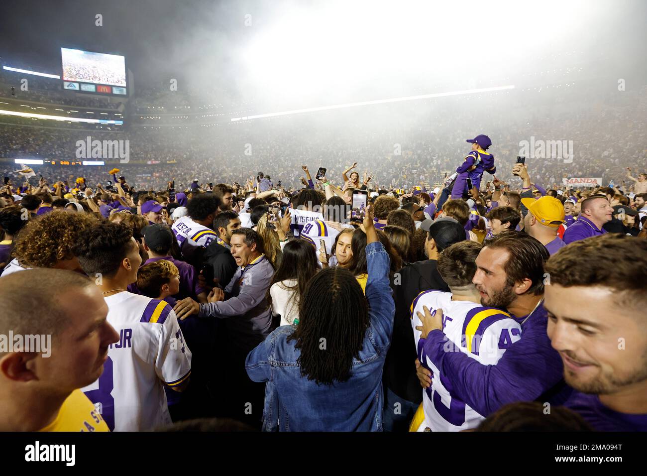 Fans storm the field after an NCAA college football game between LSU ...