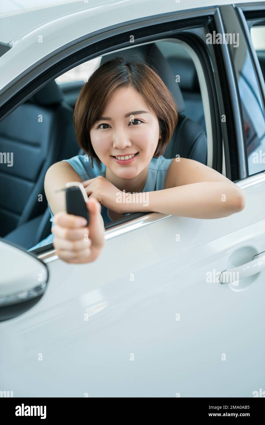 Young people in the car 4 s shop Stock Photo - Alamy