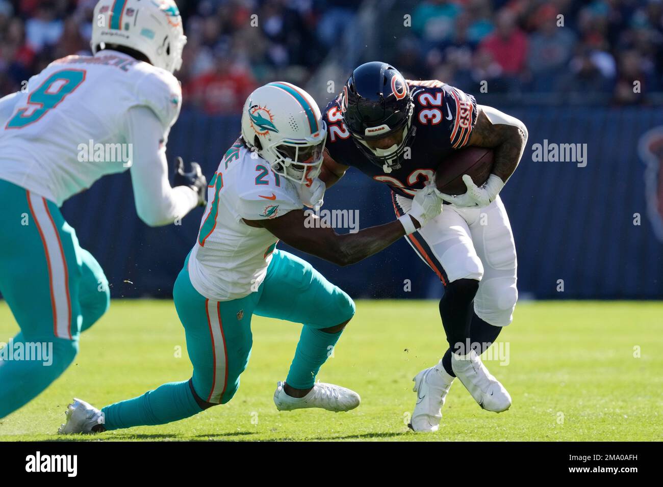 Chicago Bears running back David Montgomery, right, runs as Miami Dolphins safety Eric Rowe ...