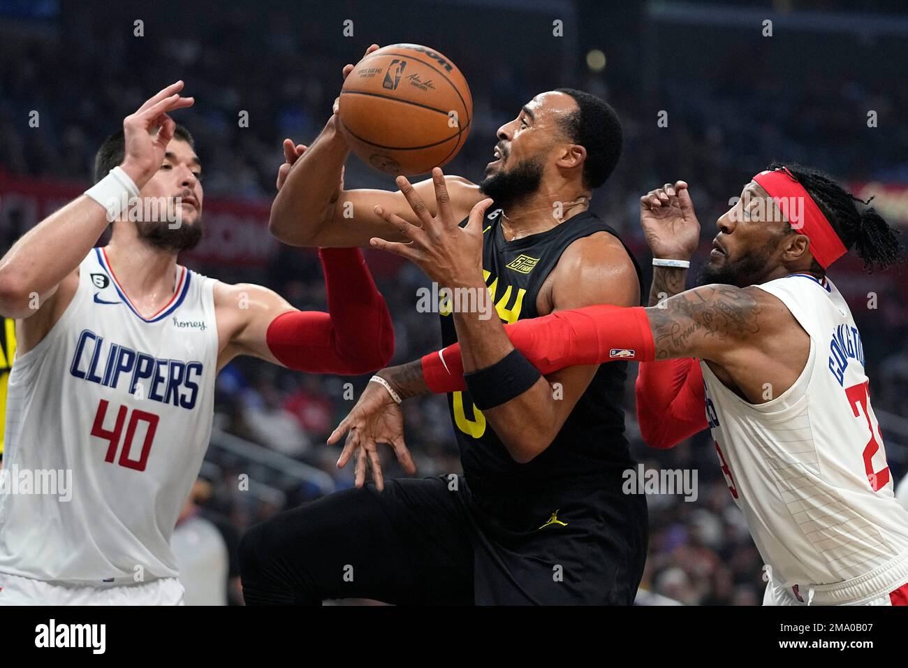 Utah Jazz guard Talen Horton-Tucker, center, shoots as Los Angeles ...