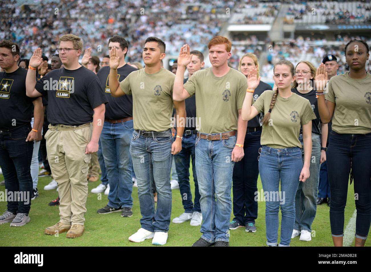Military recruits are sworn in during halftime on Salute to Service ...