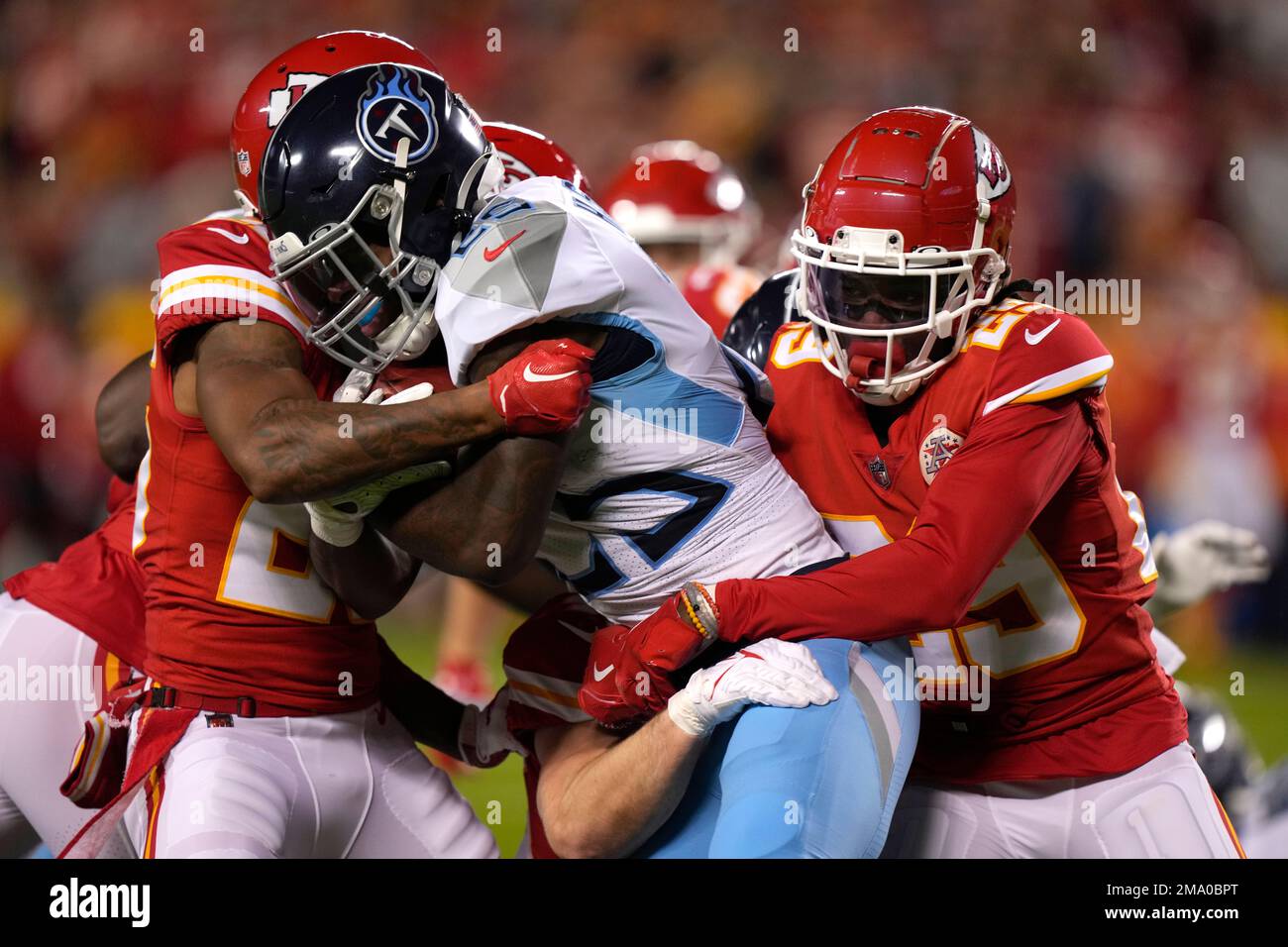 Tennessee Titans running back Hassan Haskins, center, struggles for ...