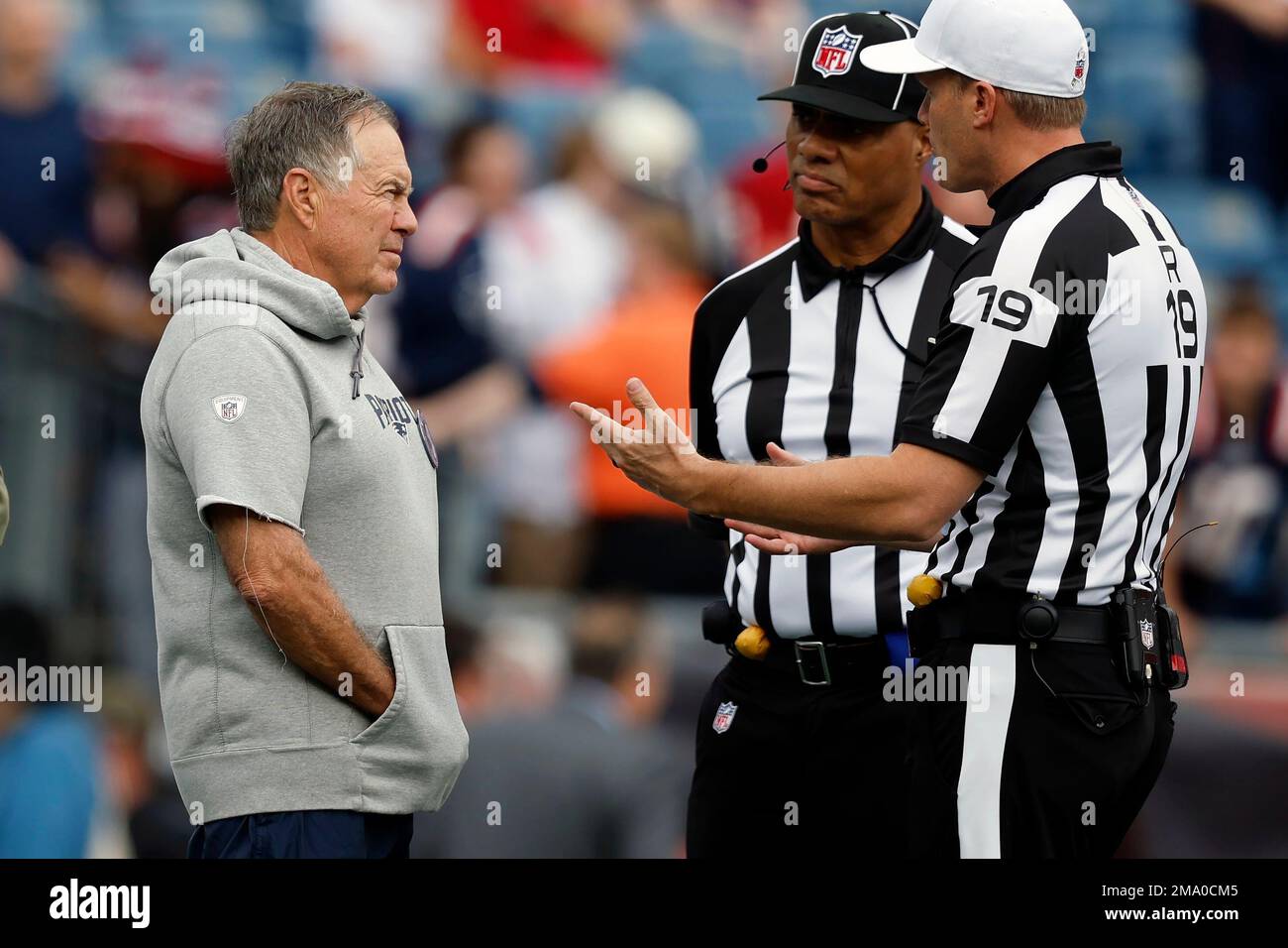 New England Patriots head coach Bill Belichick talks with referee Clay ...