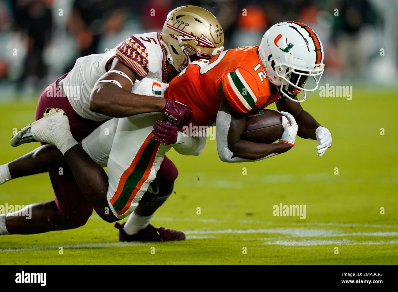 Florida State defensive lineman Jared Verse (5) tackles Miami wide ...