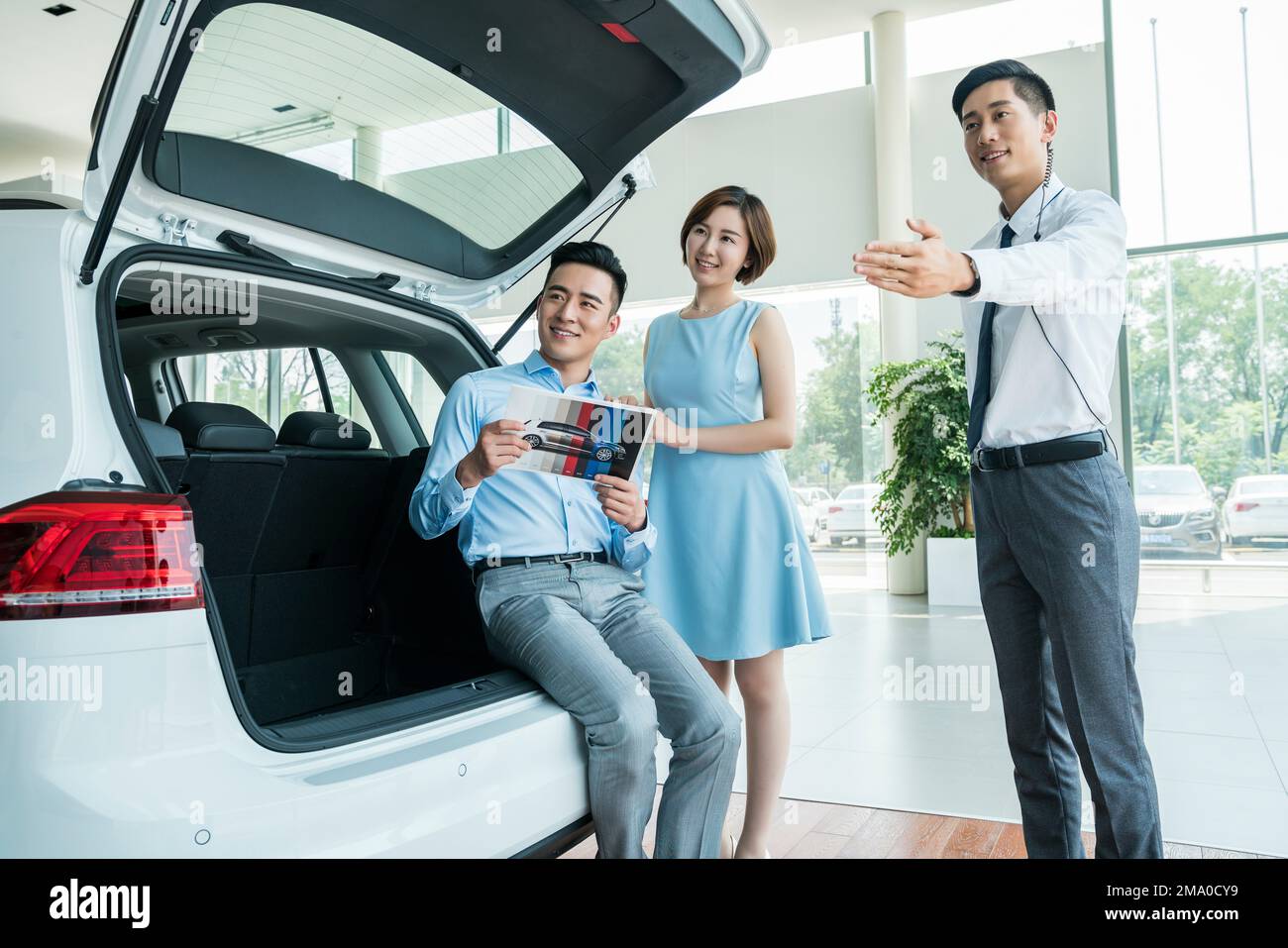 Young people in the car 4 s shop Stock Photo - Alamy