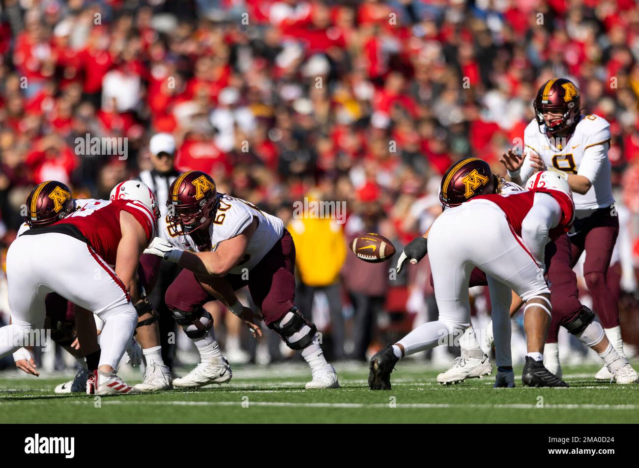Minnesota offensive lineman John Michael Schmitz (60) hikes the ball to ...