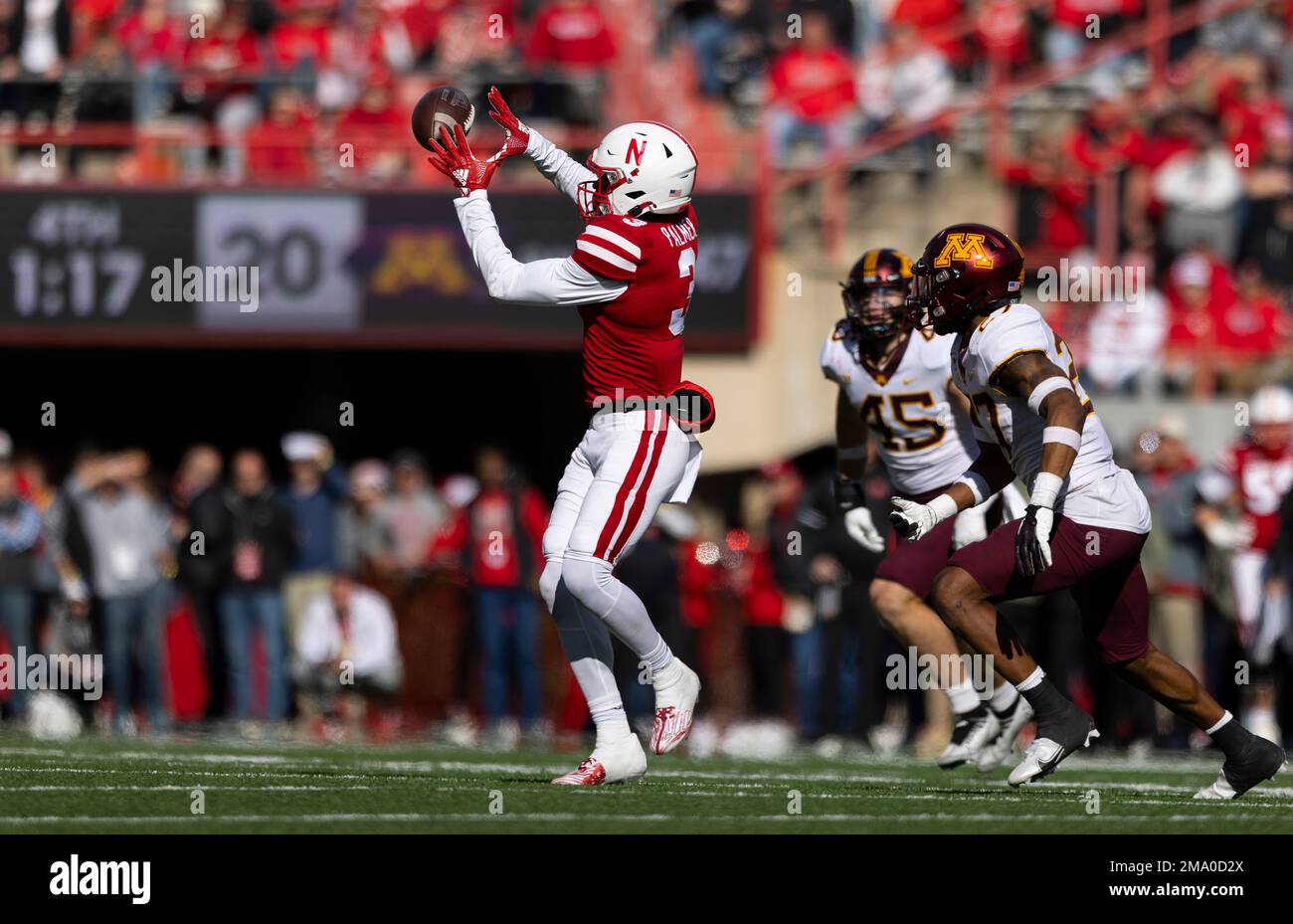 Nebraska's Trey Palmer, left, drops a pass against Minnesota's Tyler ...