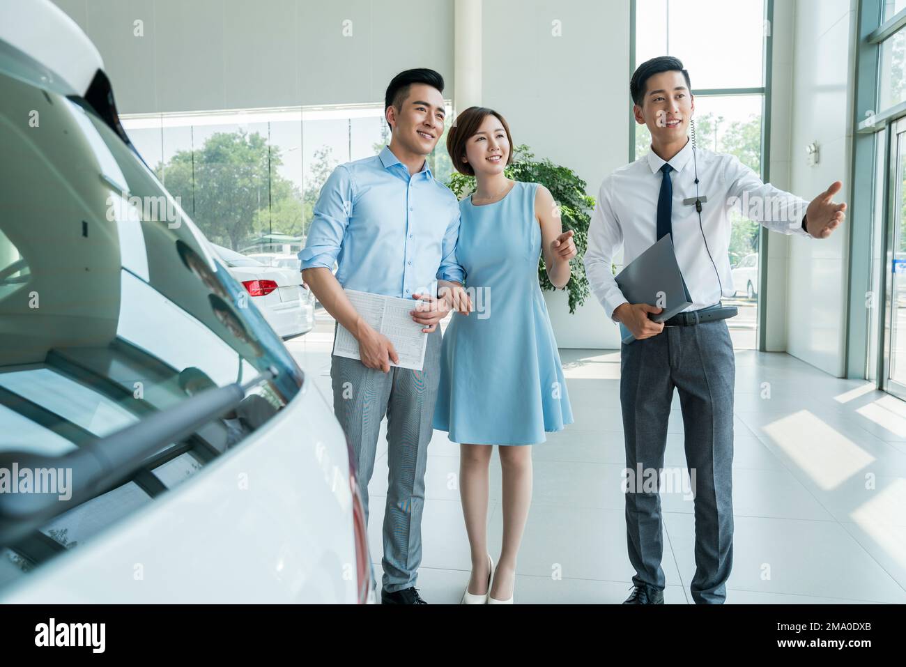 Young people in the car 4 s shop Stock Photo - Alamy