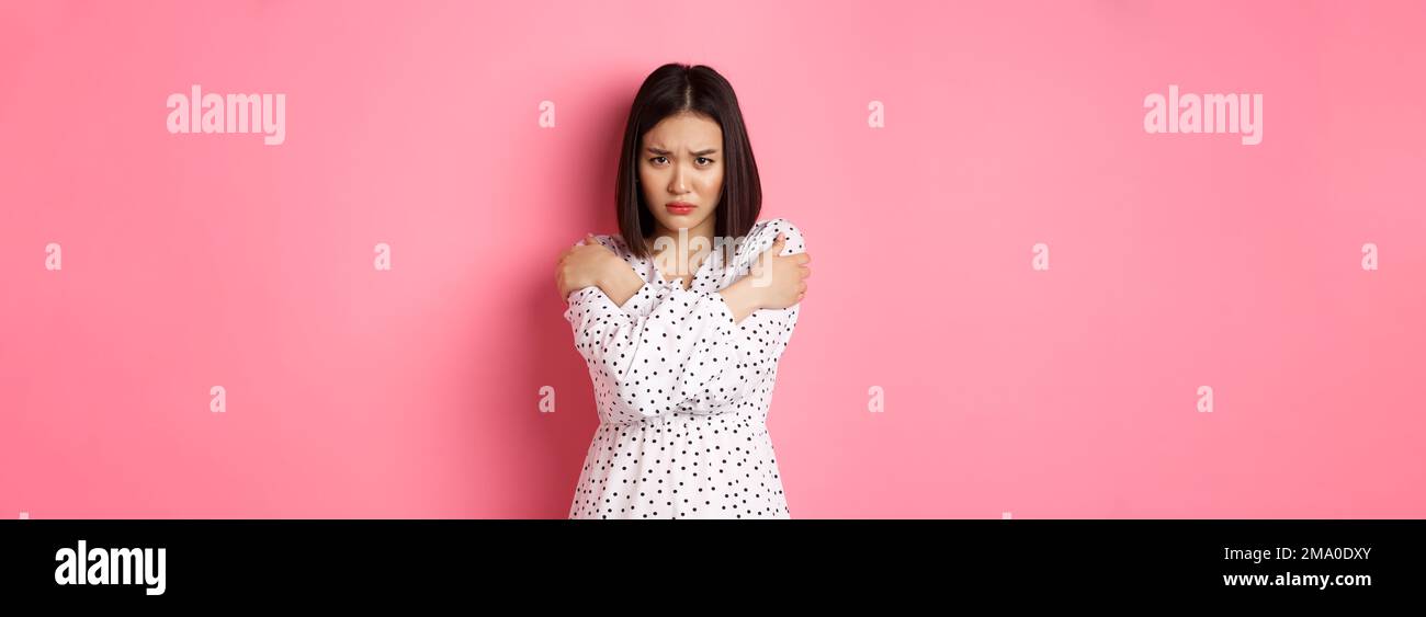Timid and offended asian girl cross arms on chest, staring defensive ...