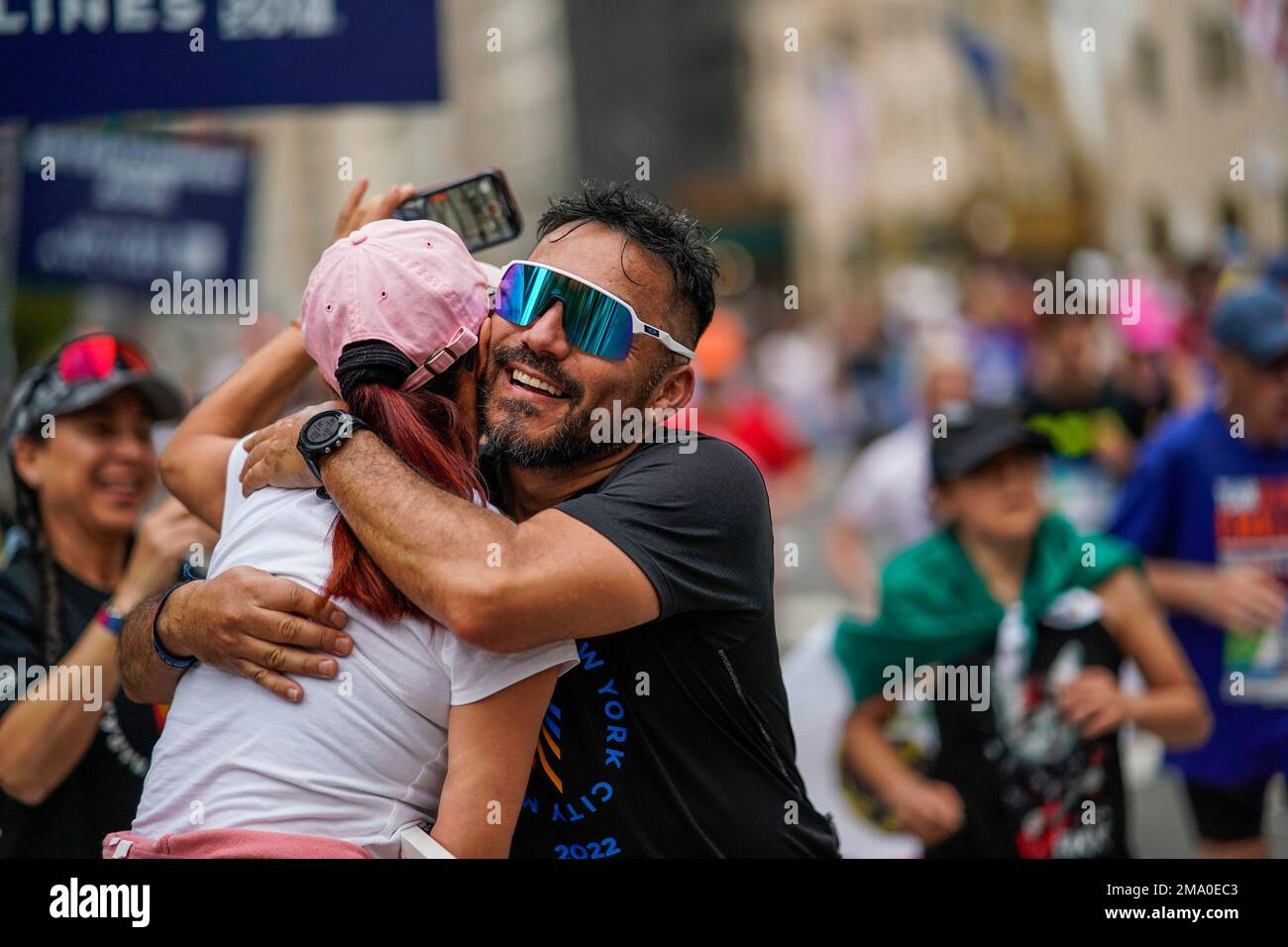 A runner hugs his relative as he takes part during the New York City ...