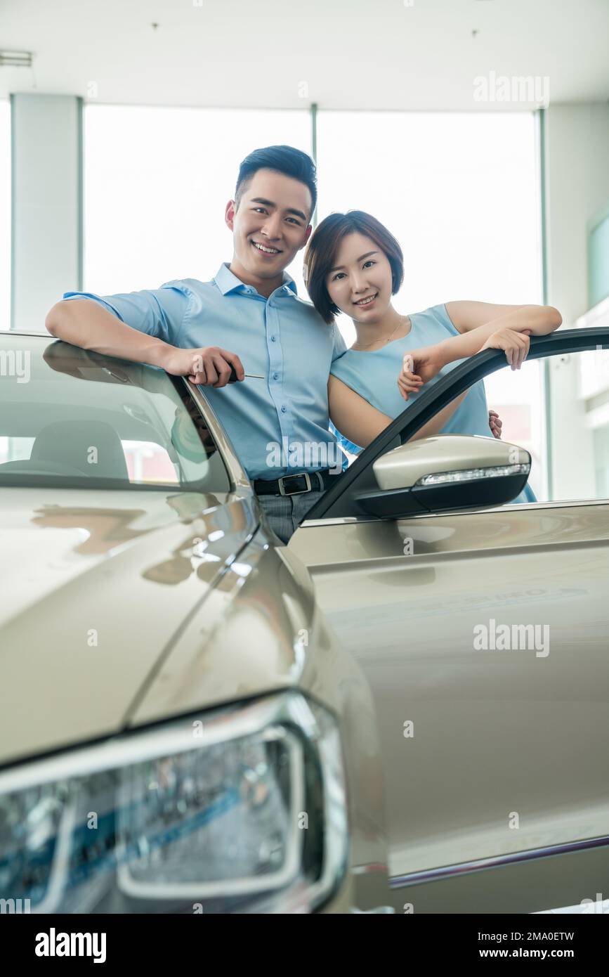 Young people in the car 4 s shop Stock Photo - Alamy