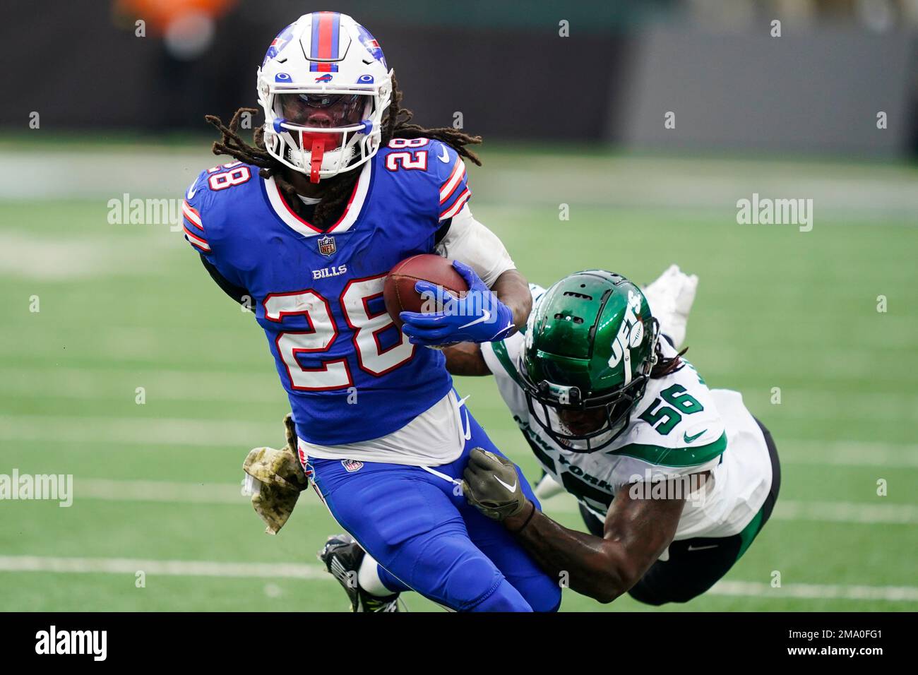 Buffalo Bills running back James Cook (28) breaks a tackle by New York ...
