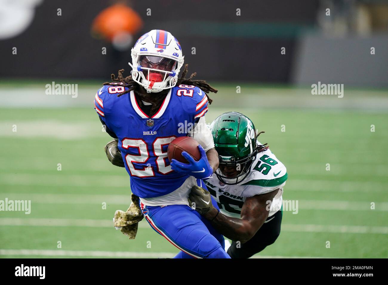 Buffalo Bills running back James Cook (28) breaks a tackle by New York ...