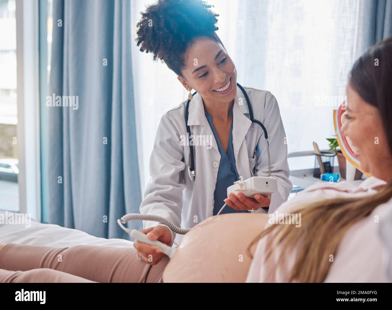 Woman, pregnancy and doctor, ultrasound at clinic with happiness ...
