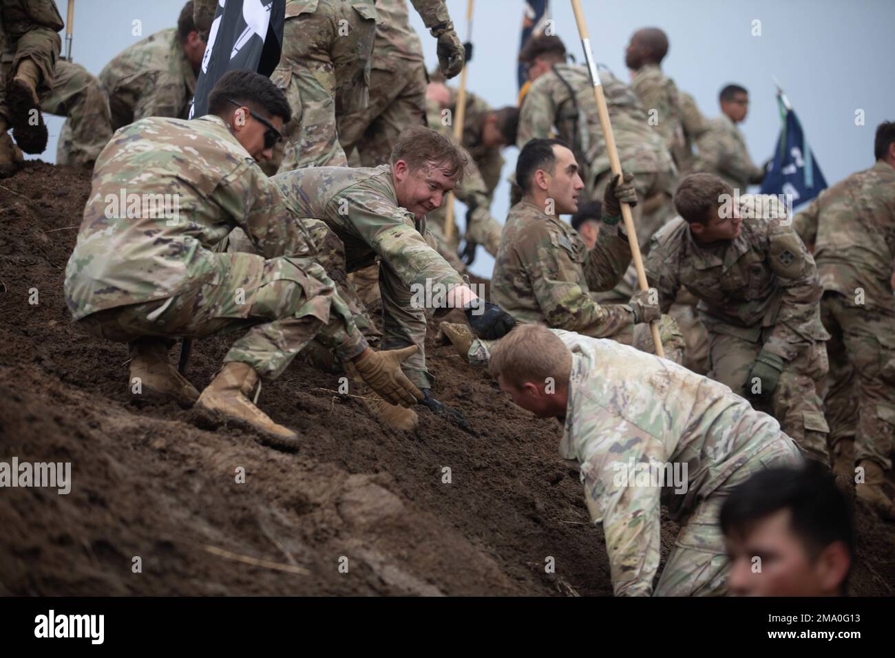 Soldiers assigned to the 4th Infantry Division help each other out of ...