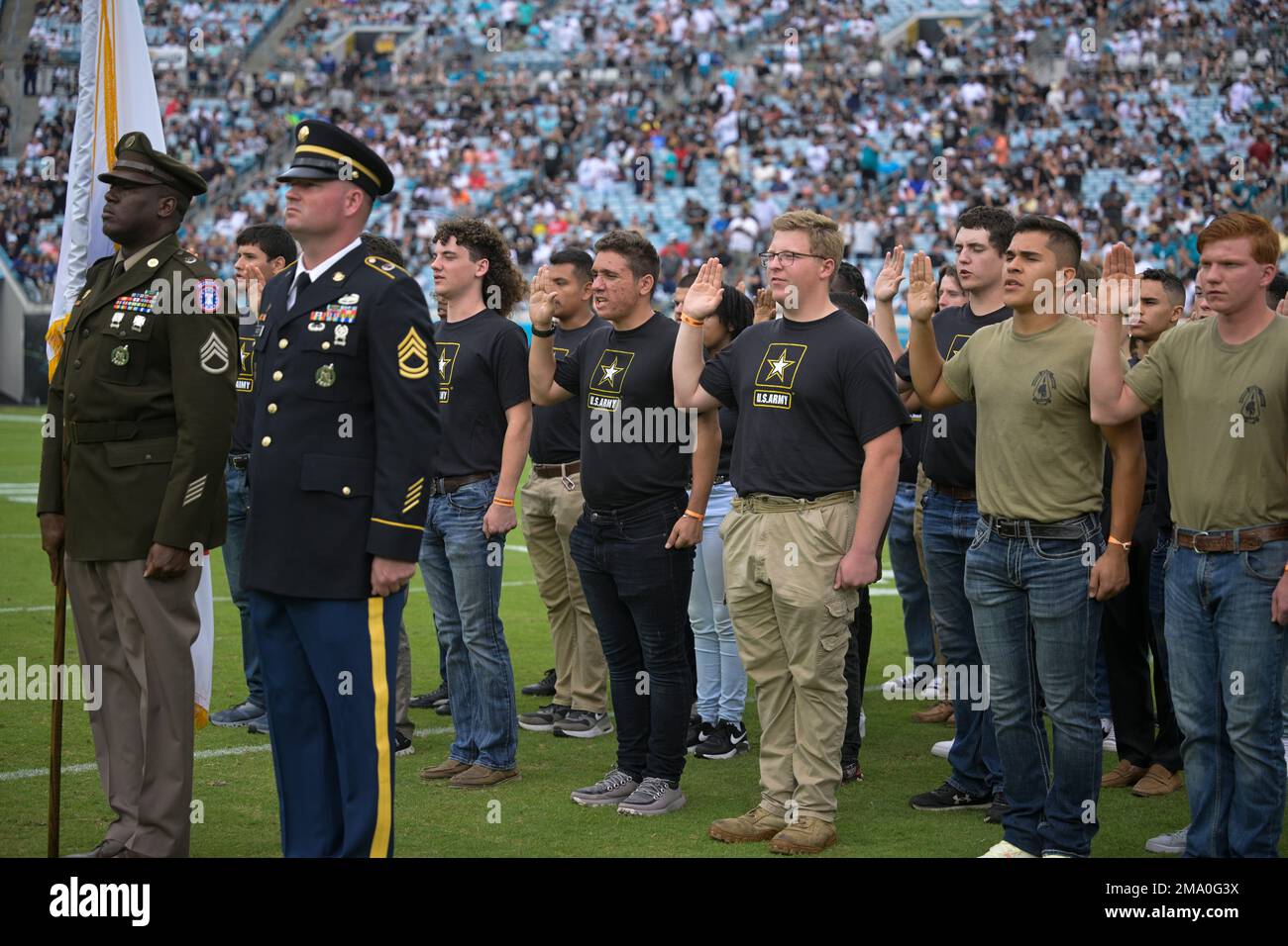 Military recruits are sworn in during halftime on Salute to Service ...