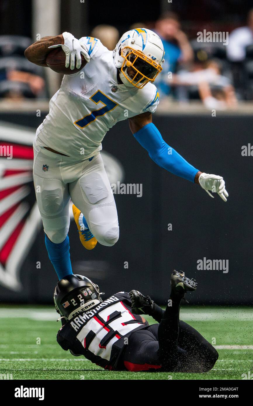 Los Angeles Chargers tight end Gerald Everett (7) is tripped up by ...