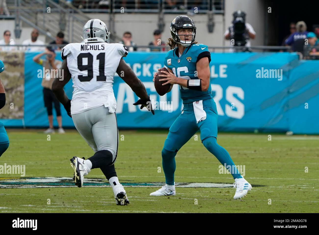 Jacksonville Jaguars quarterback Trevor Lawrence (16) is pressured by ...