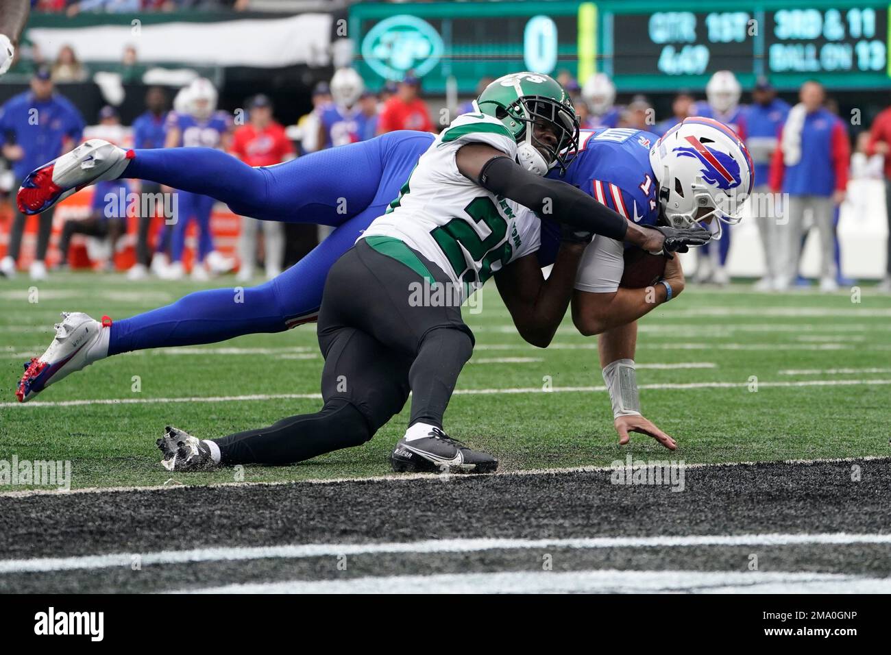 Buffalo Bills quarterback Josh Allen, right, dives past New York Jets ...