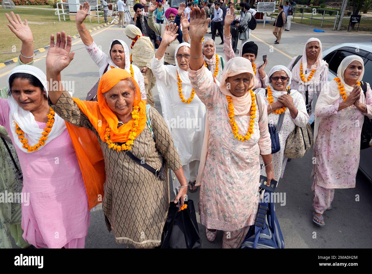 Indian Sikh pilgrims wave to journalists while entering Pakistan ...