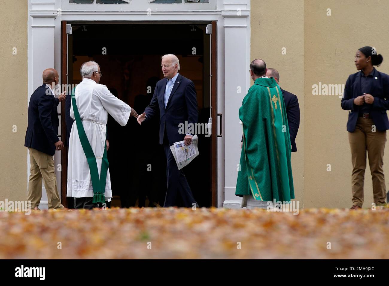 President Joe Biden speaks with priests as he departs after attending ...