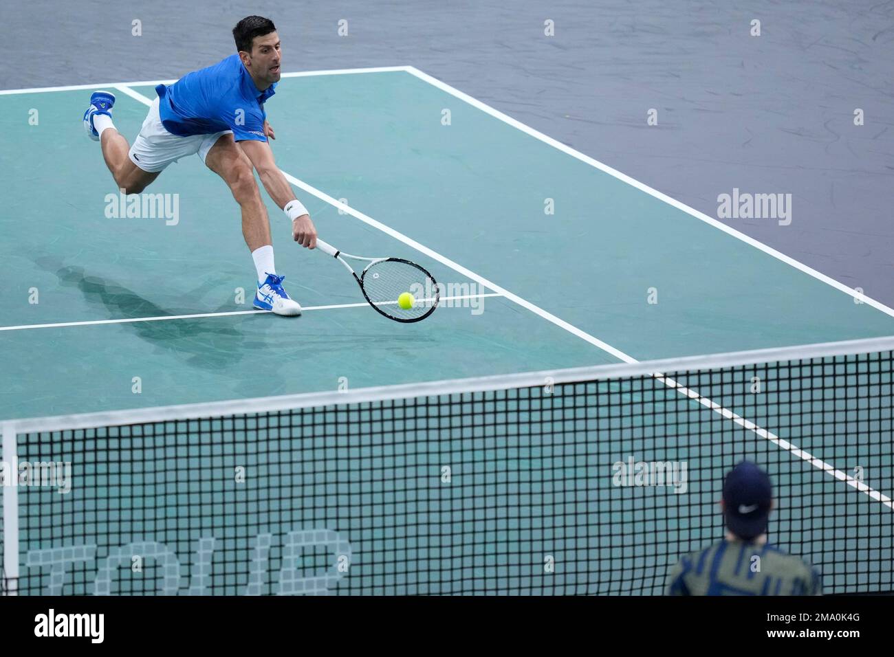 Serbia's Novak Djokovic, top, stretches to return the ball to Denmark's Holger Rune during their ...