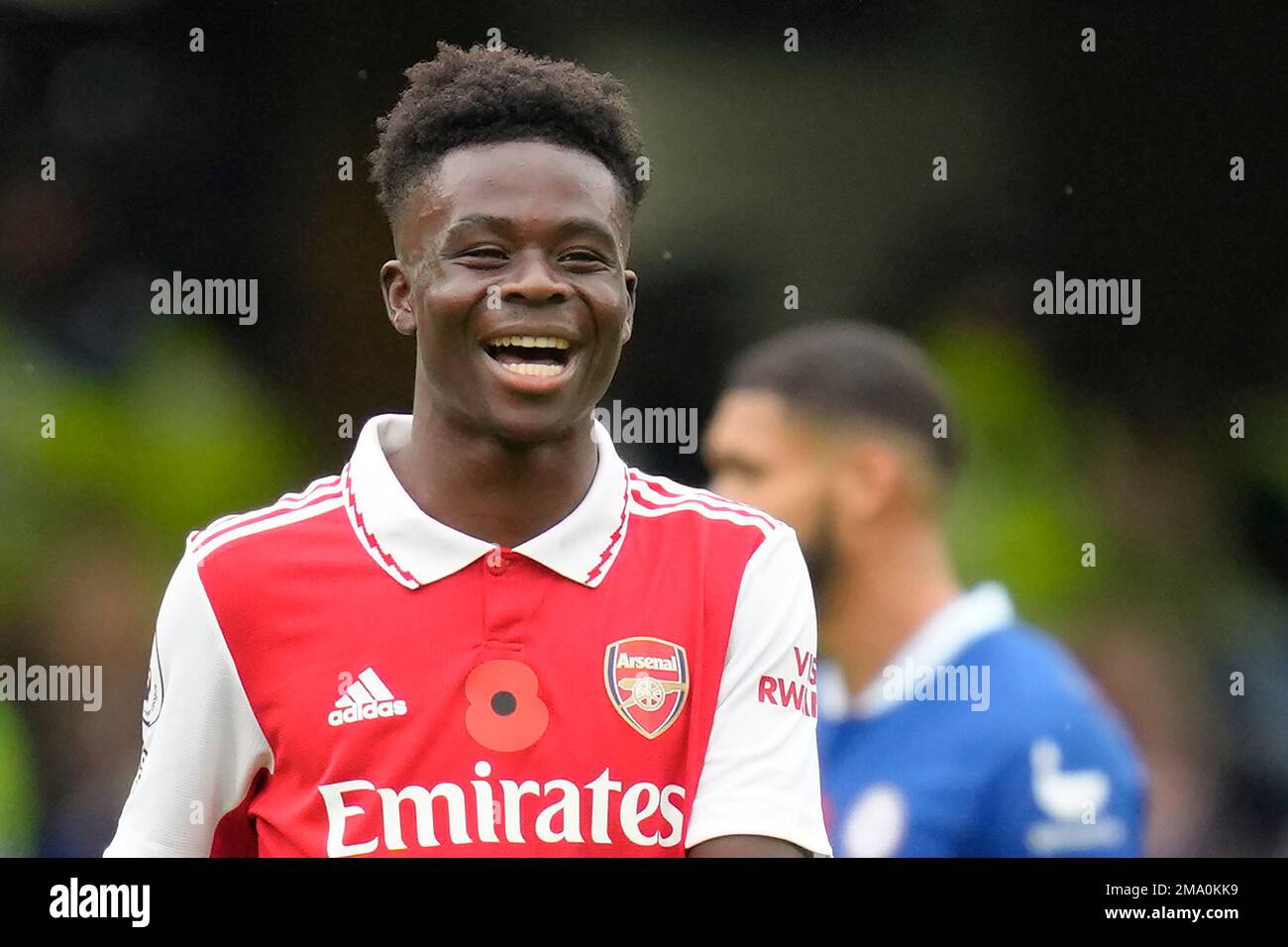 Arsenal's Bukayo Saka smiles after scoring the opening goal during the ...