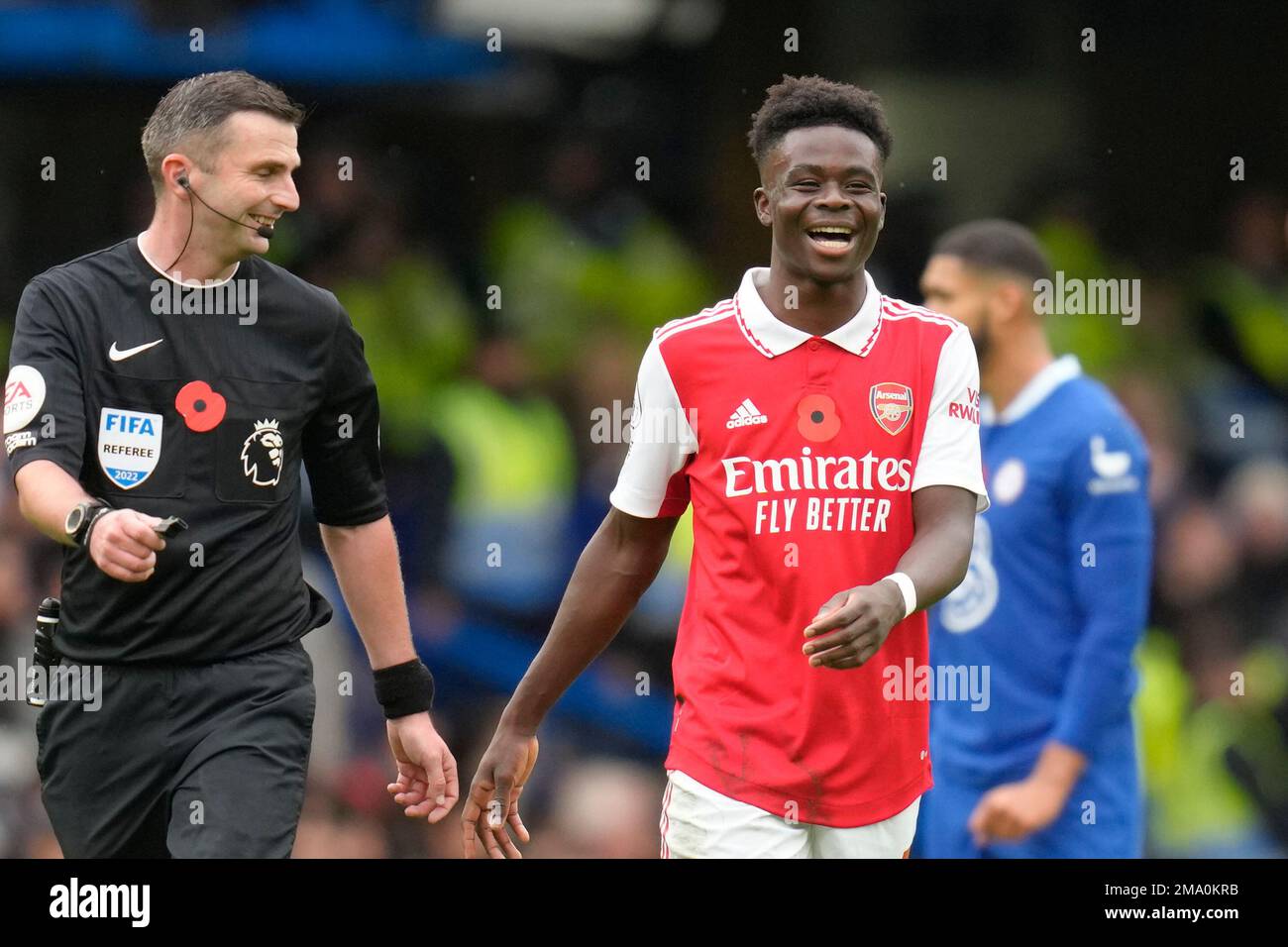 Arsenal's Bukayo Saka, centre, smiles after scoring the opening goal ...