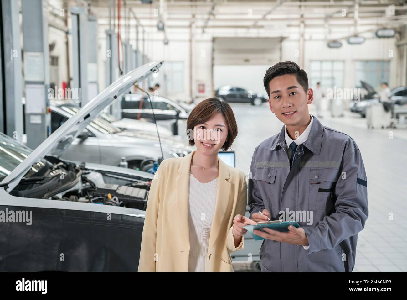 Repair shop mechanics of personnel with the customer Stock Photo - Alamy