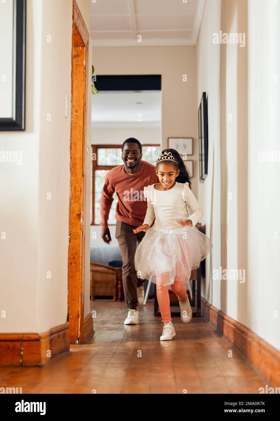 Family, father and daughter running in a house, smile and happy while ...