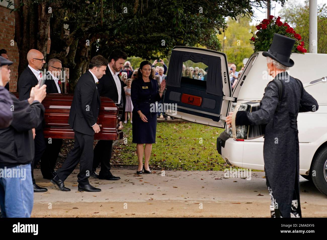 Pallbearers carry the casket of rock and roll pioneer Jerry Lee Lewis ...