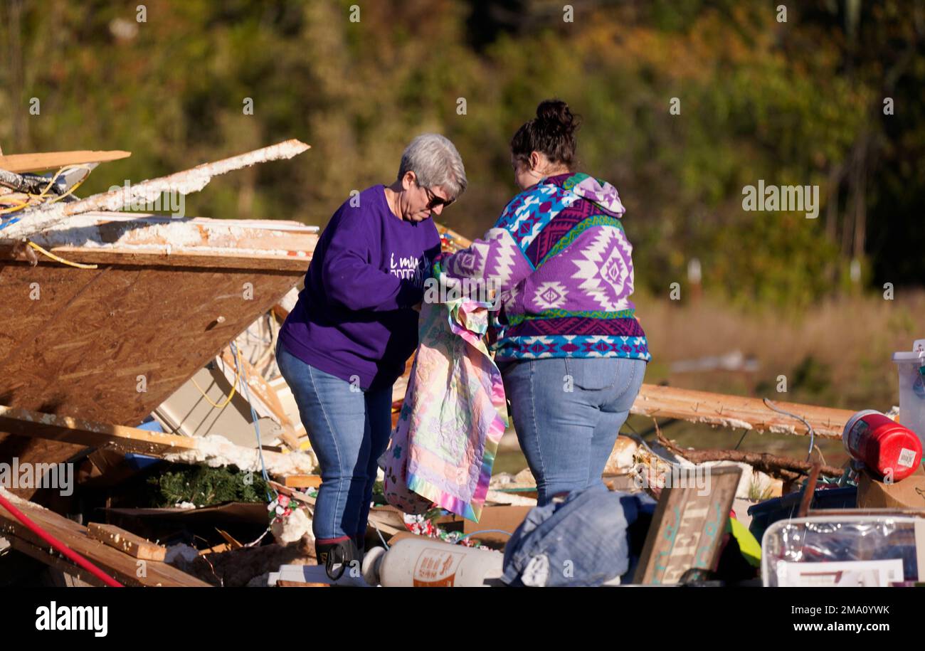 Shawn Weems, left, helps her daughter Sydnie Dooley salvage items from ...