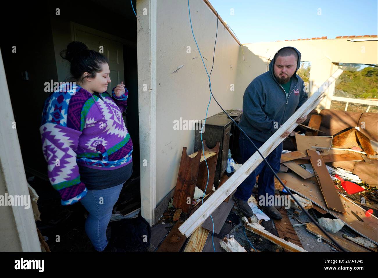 Nathan Dooley, right, and his wife Sydnie Dooley look for items to ...