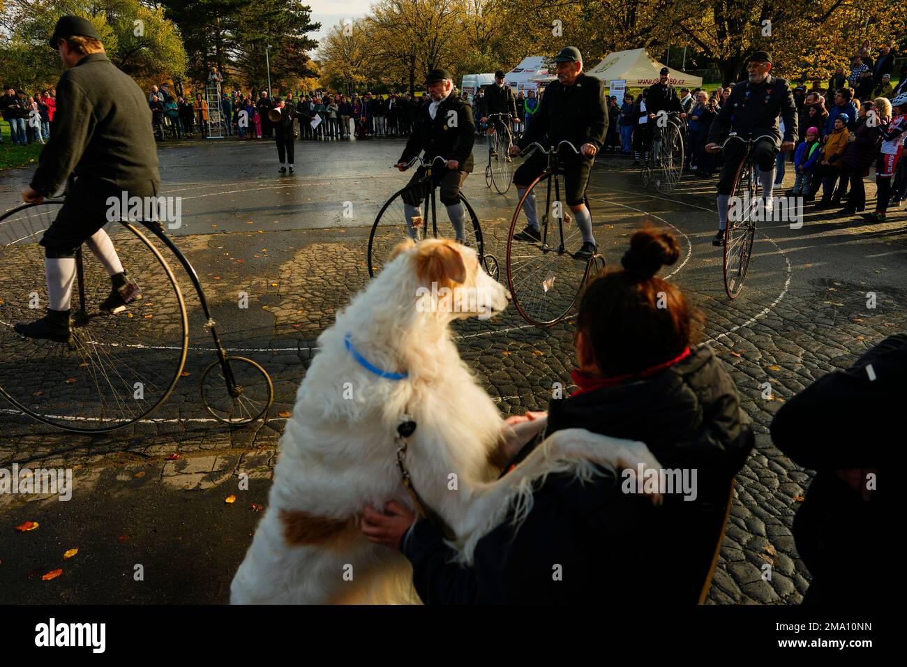 Enthusiasts dressed in historical costumes enjoy a ride on their penny ...