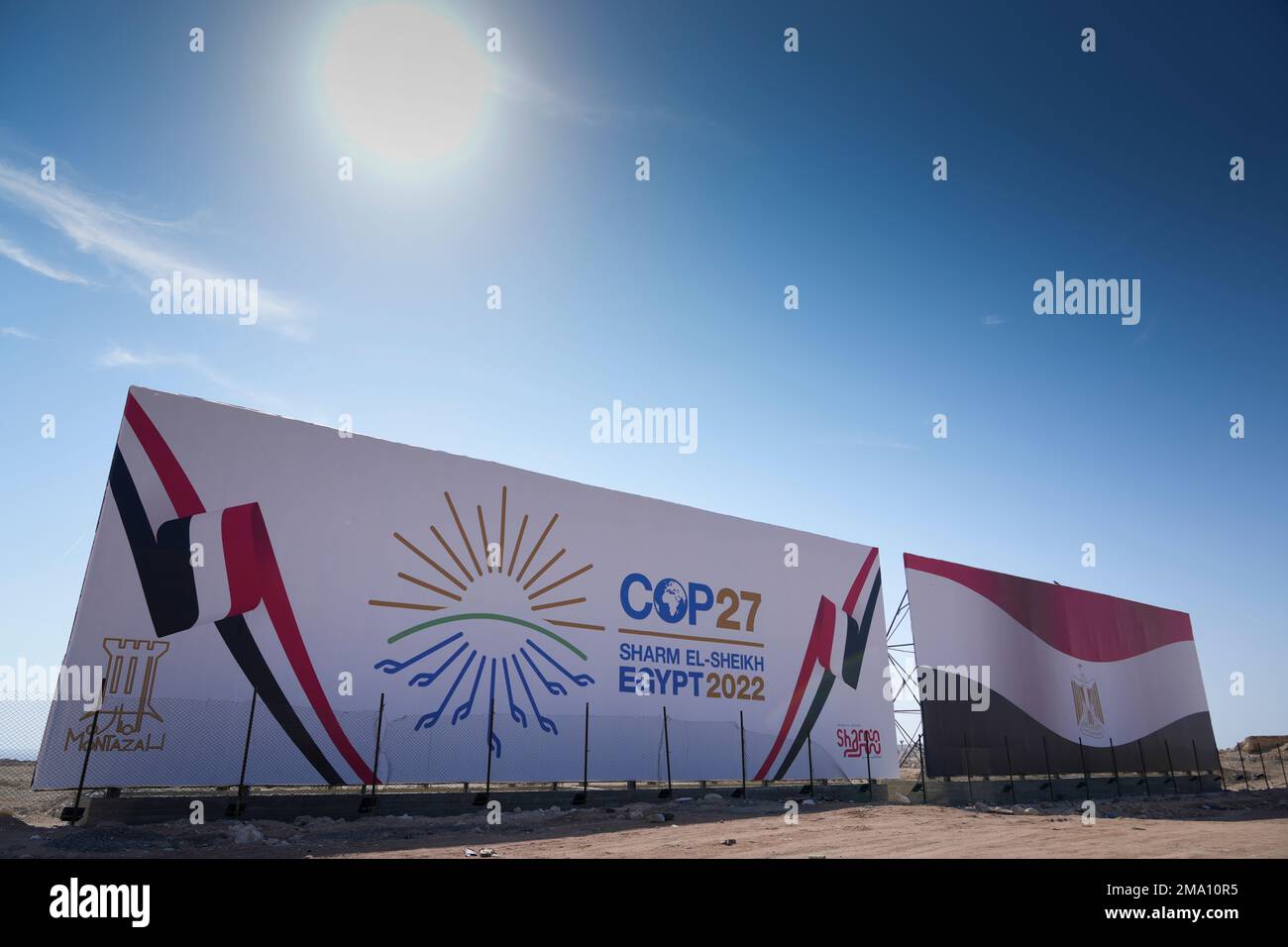 The COP27 U.N. Climate Summit logo and the Egyptian flag are displayed ...