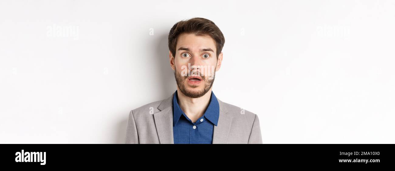 Close up portrait of shocked caucasian man in suit drop jaw, looking ...