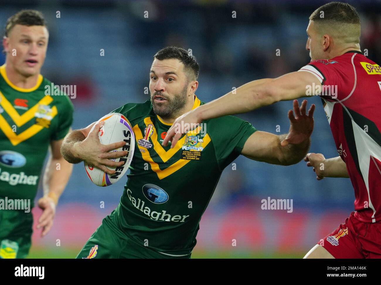 Australia's captain James Tedesco, left, avoids a tackle by Lebanon's ...