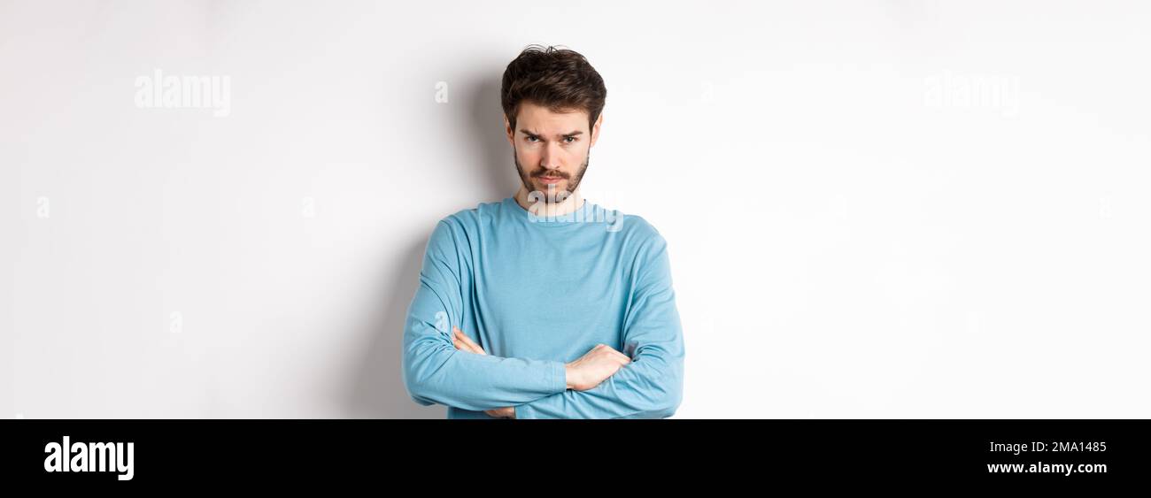 Image of offended and sad young man with beard, look from under ...