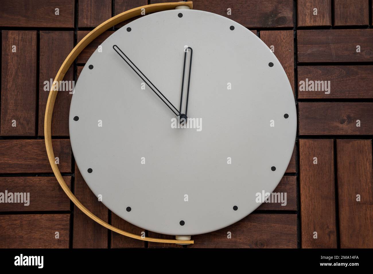 Wall clock at wooden background texture. Flat lay top view composition ...