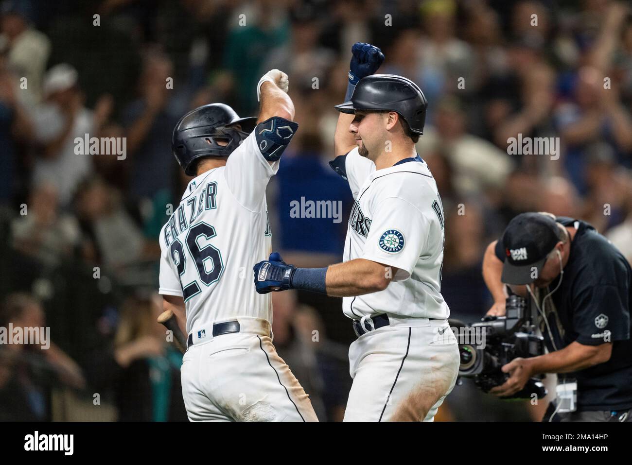 Seattle Mariners' Cal Raleigh, right, is congratulated by teammate Adam ...