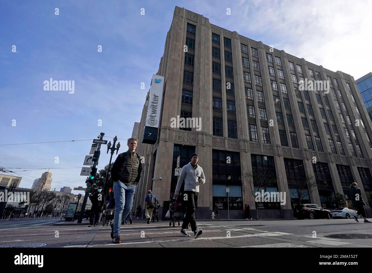 People walk outside Twitter headquarters in San Francisco, Friday, Nov ...