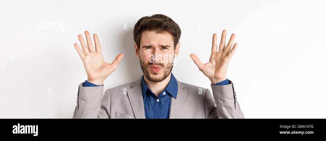 Close-up of disappointed and disgusted businessman raising hands up ...