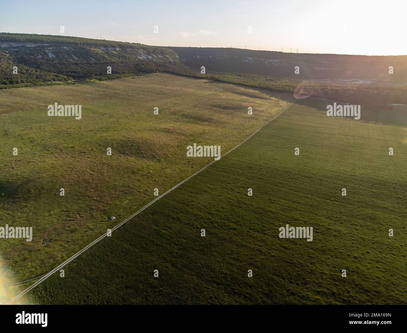 Aerial view on green wheat field, road and hills in countryside. Field ...