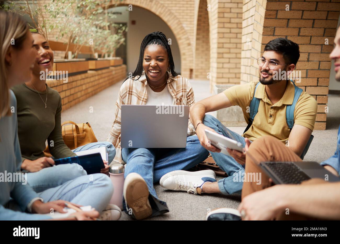 Diversity, laptop and students on ground, conversation and connection ...