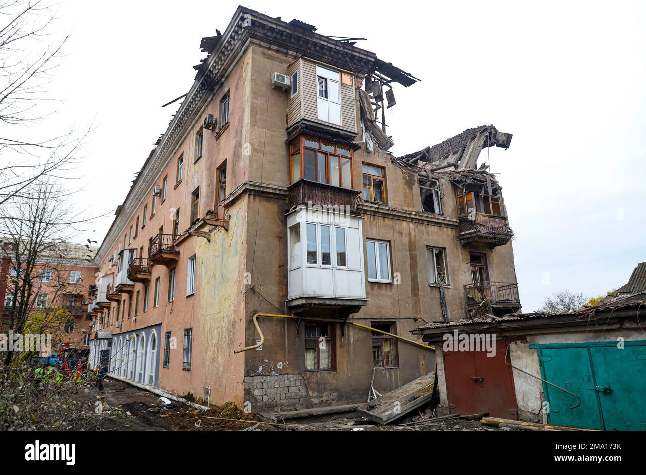 Rescuers, left, work at a site of a damaged apartment building after ...